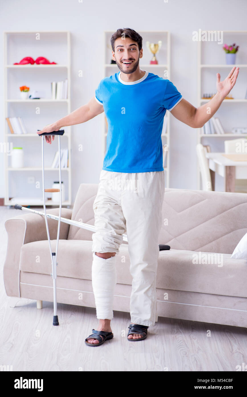 Injured young man recovering at home Stock Photo - Alamy