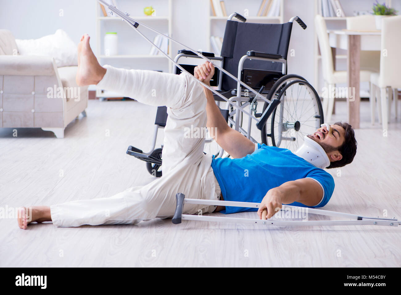 Injured young man recovering at home Stock Photo - Alamy