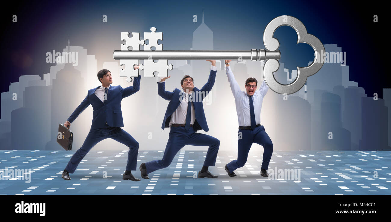Businessmen holding giant key in business concept Stock Photo - Alamy