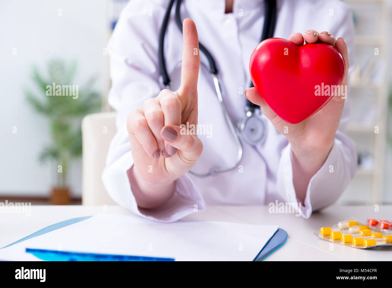Smiling doctor man red heart medicine hi-res stock photography and ...