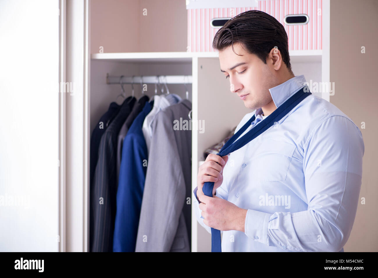 Young man businessman getting dressed for work Stock Photo - Alamy