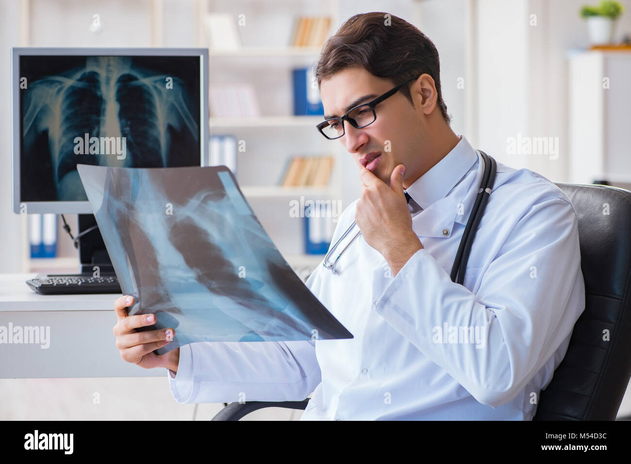 Doctor radiologist looking at x-ray images Stock Photo - Alamy