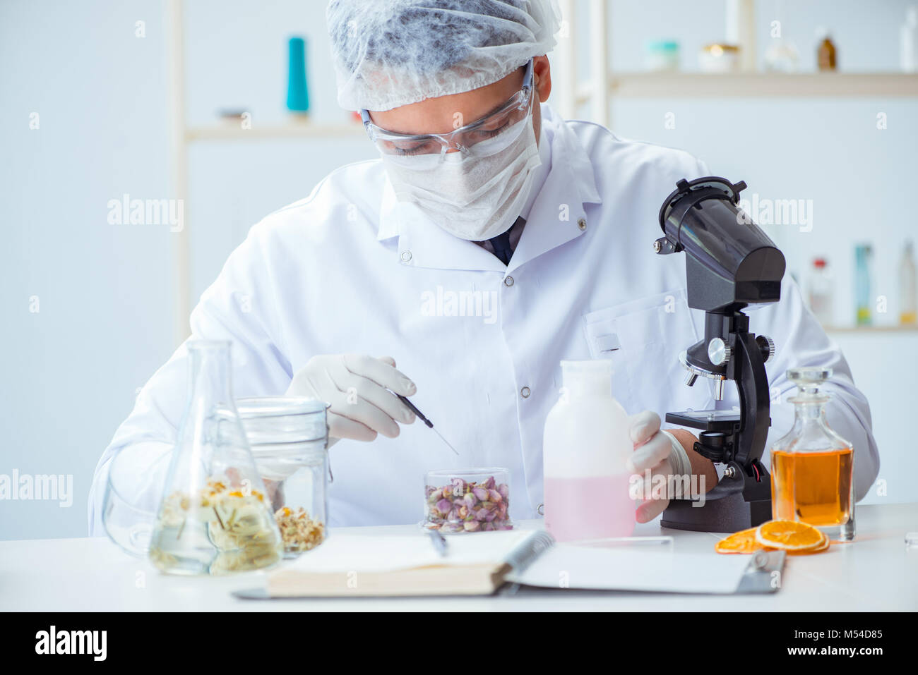 Chemist mixing perfumes in the lab Stock Photo - Alamy