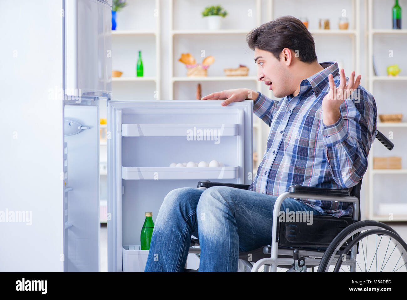 Young disabled injured man opening the fridge door hi-res stock ...