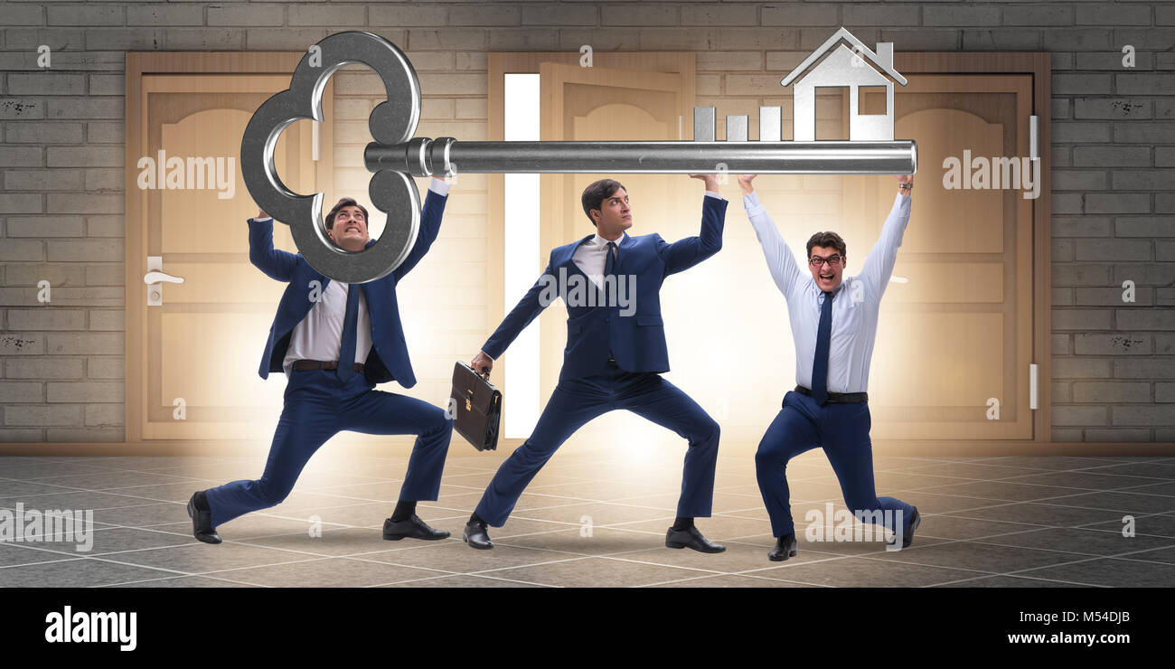 Businessmen holding giant key in real estate concept Stock Photo - Alamy