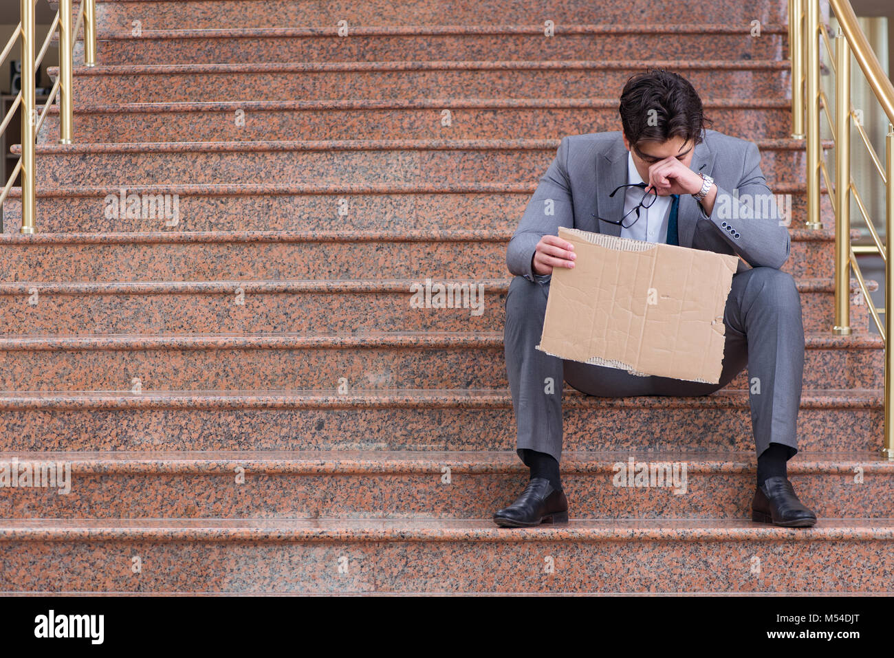 Desperate businessman begging on the street Stock Photo - Alamy