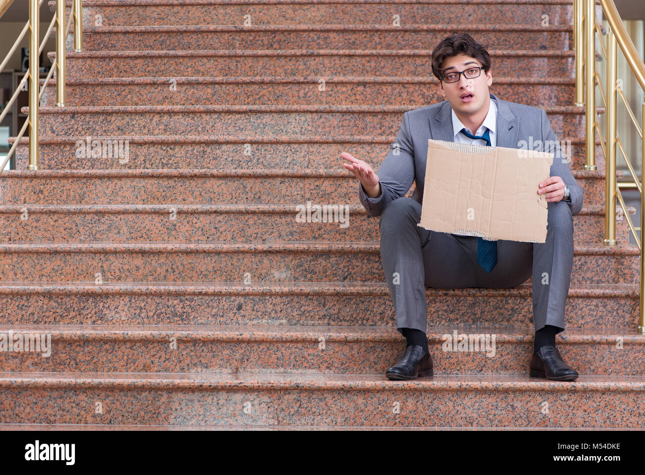 Desperate businessman begging on the street Stock Photo - Alamy
