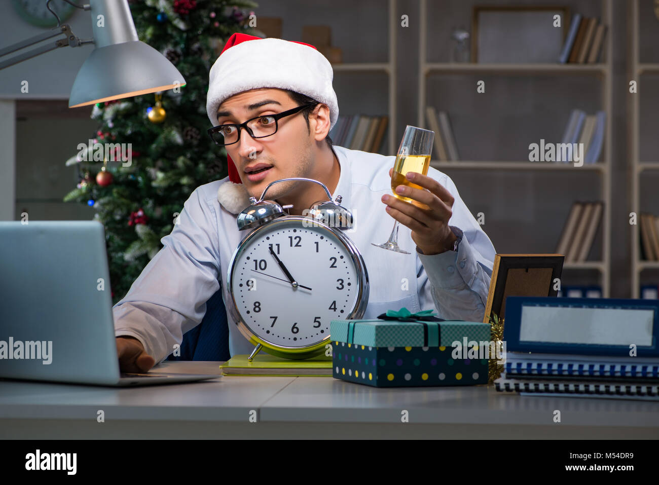 Businessman working late on christmas day in office Stock Photo - Alamy