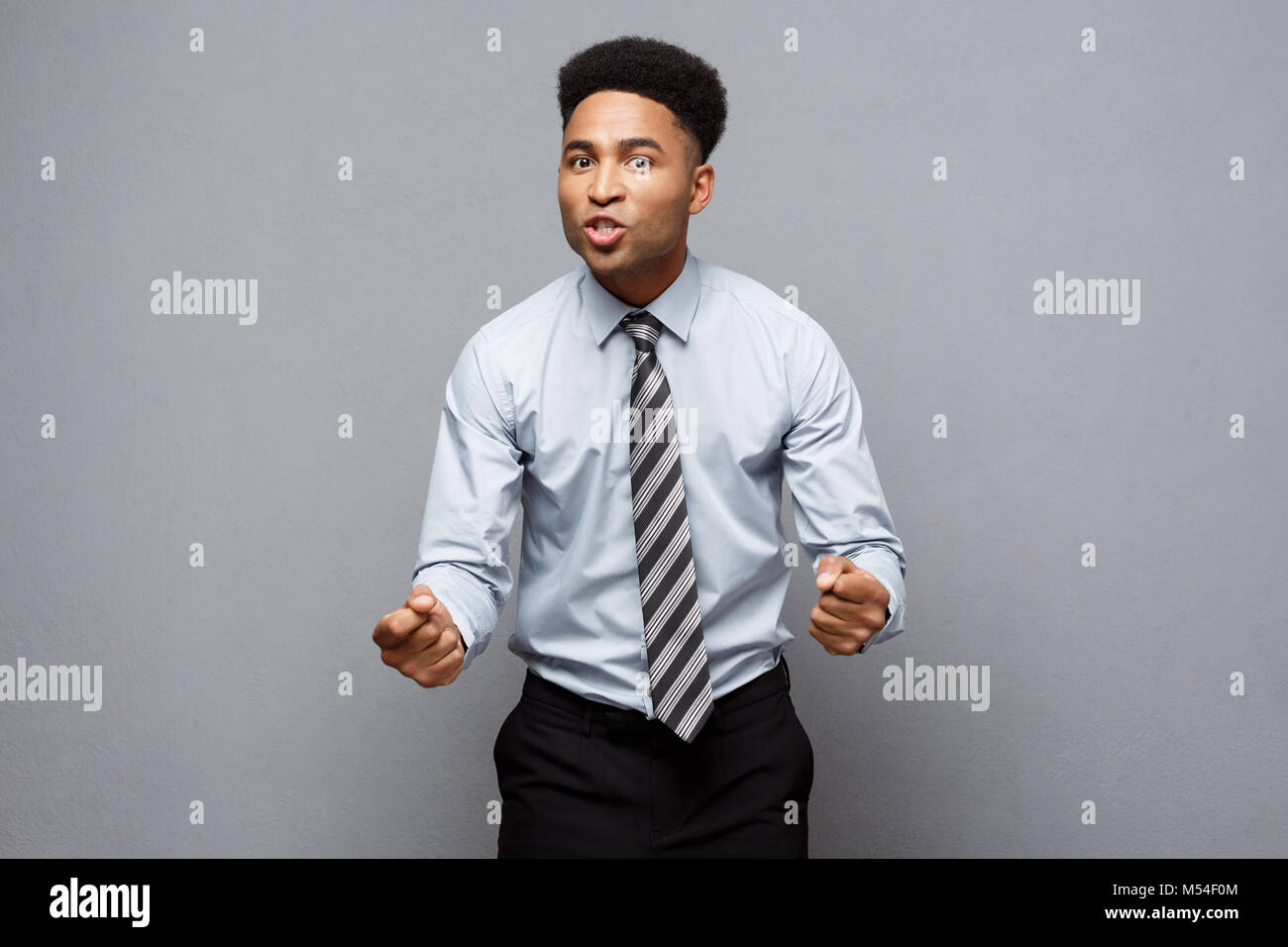 Business Concept - Angry African American with confused screaming with ...