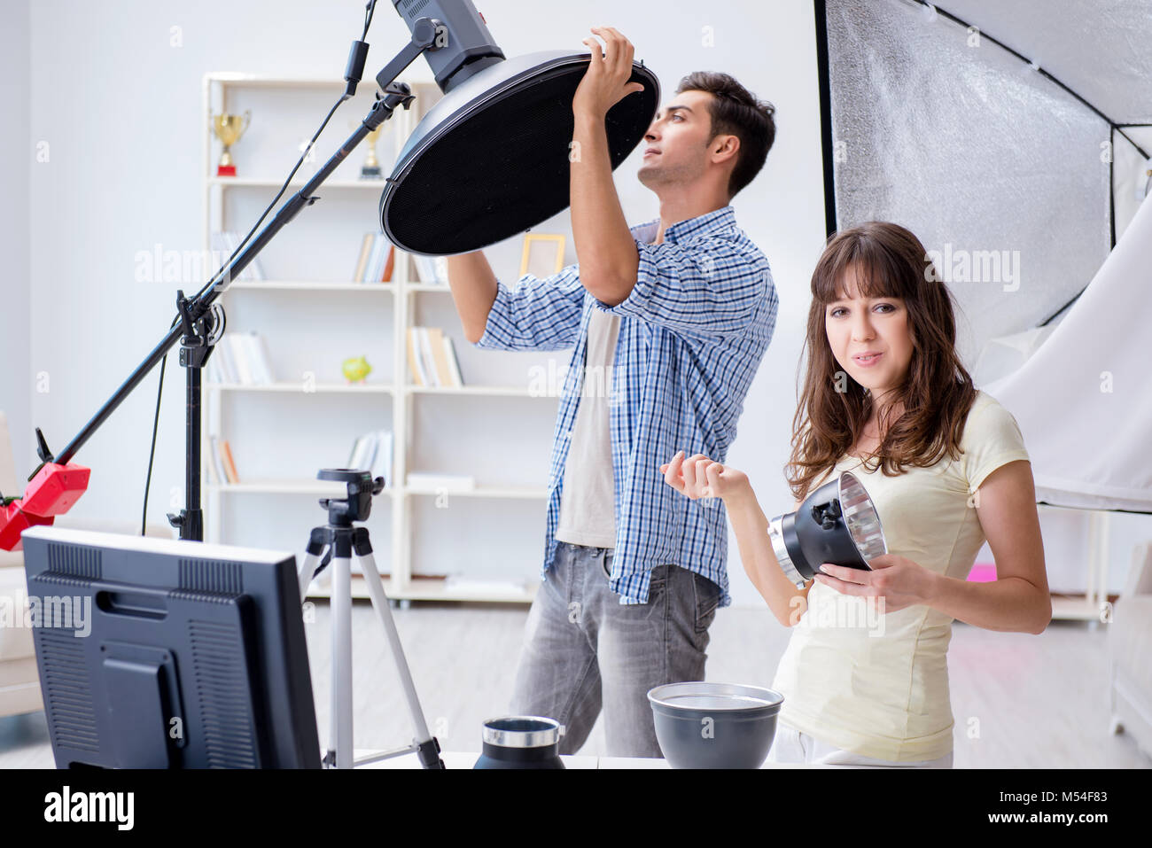 Young photographer working in photo studio Stock Photo - Alamy