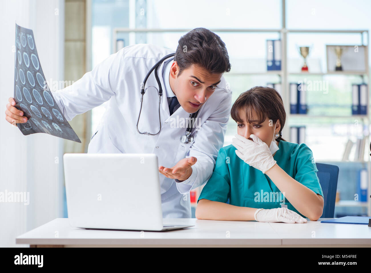 Two doctors discussing x-ray MRI image in hospital Stock Photo - Alamy