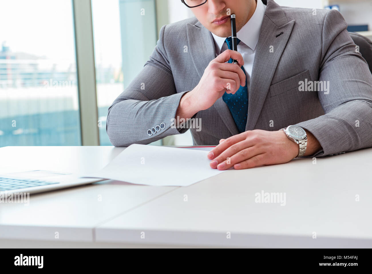 Businessman signing business documents in office Stock Photo - Alamy