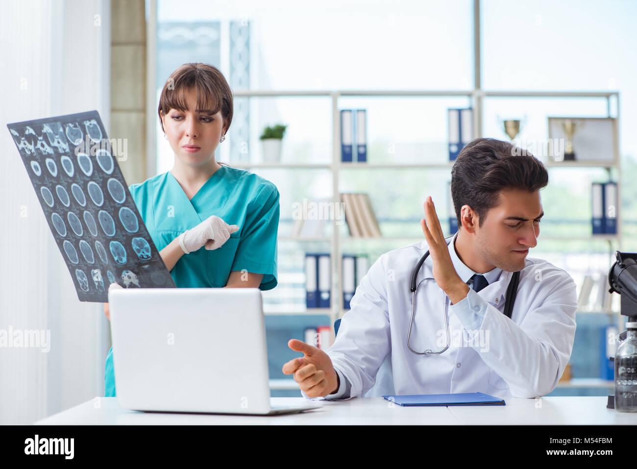 Two doctors discussing x-ray MRI image in hospital Stock Photo - Alamy