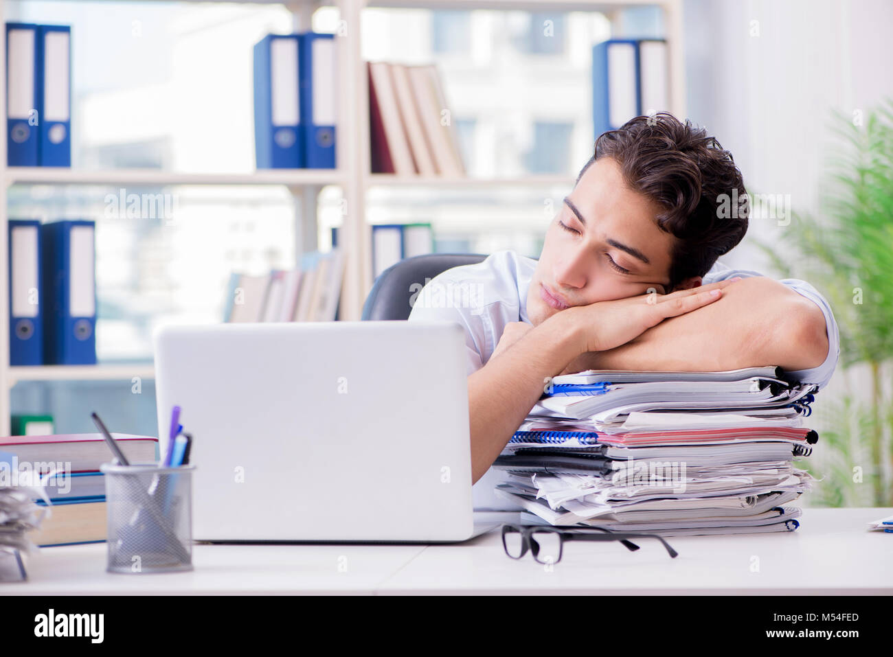Tired exhausted businessman sitting in the office Stock Photo - Alamy