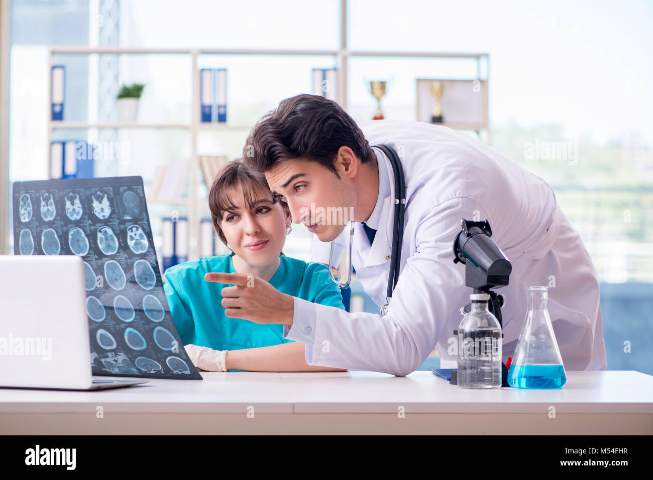 Two doctors discussing x-ray MRI image in hospital Stock Photo - Alamy