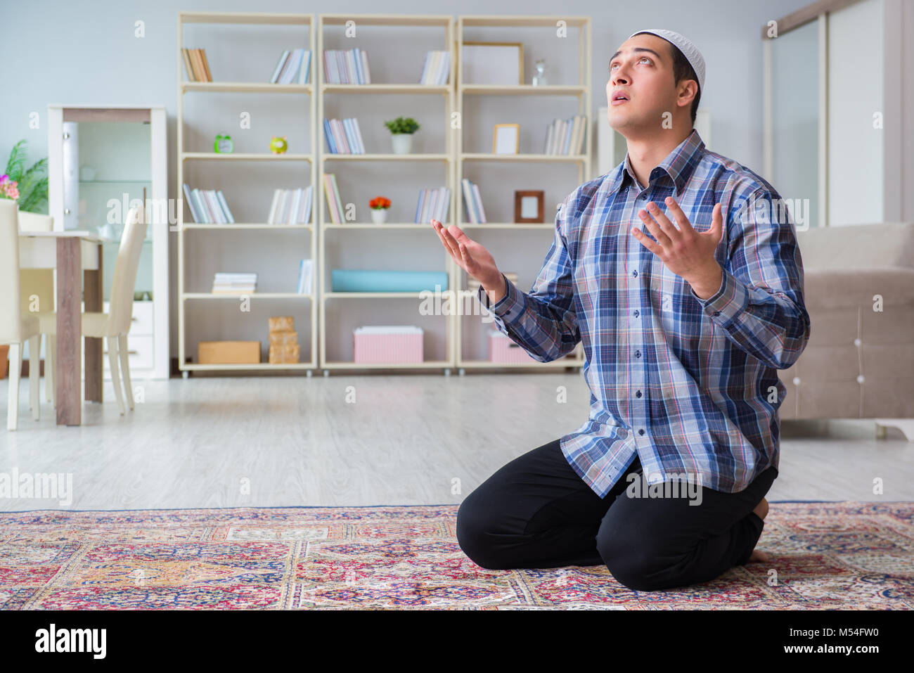 Young muslim man praying at home Stock Photo - Alamy