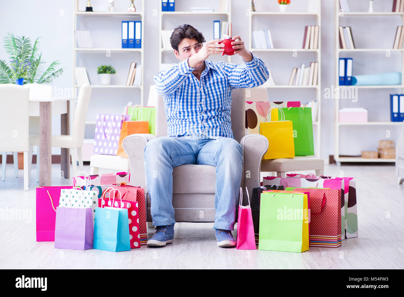 Young man after excessive shopping at home Stock Photo - Alamy
