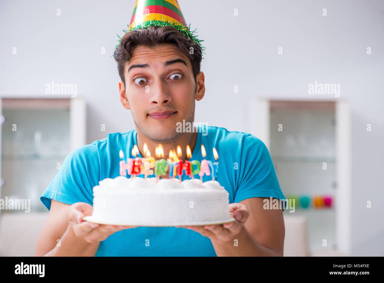 Young man celebrating birthday alone at home Stock Photo - Alamy