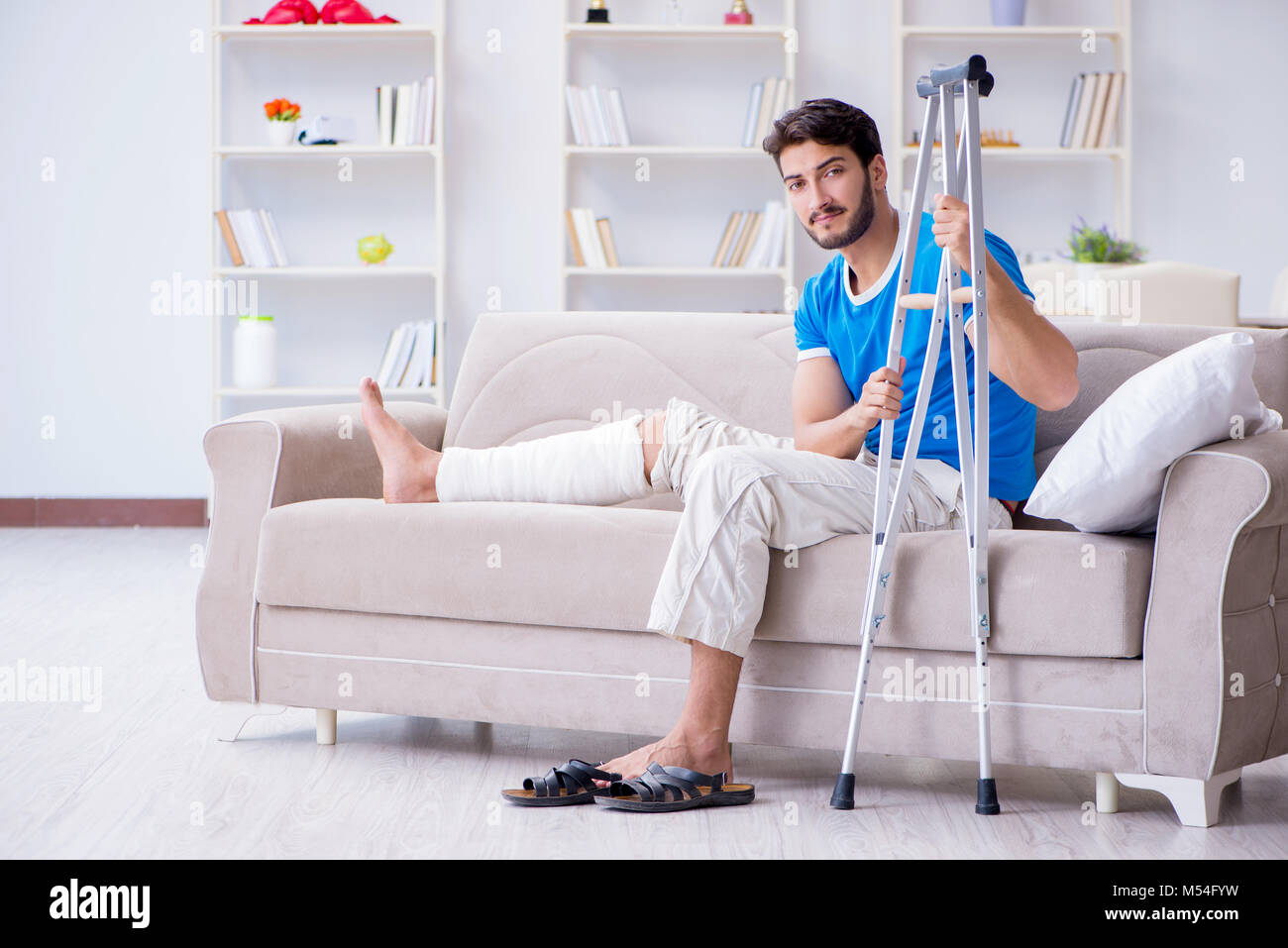 Injured young man recovering at home Stock Photo - Alamy