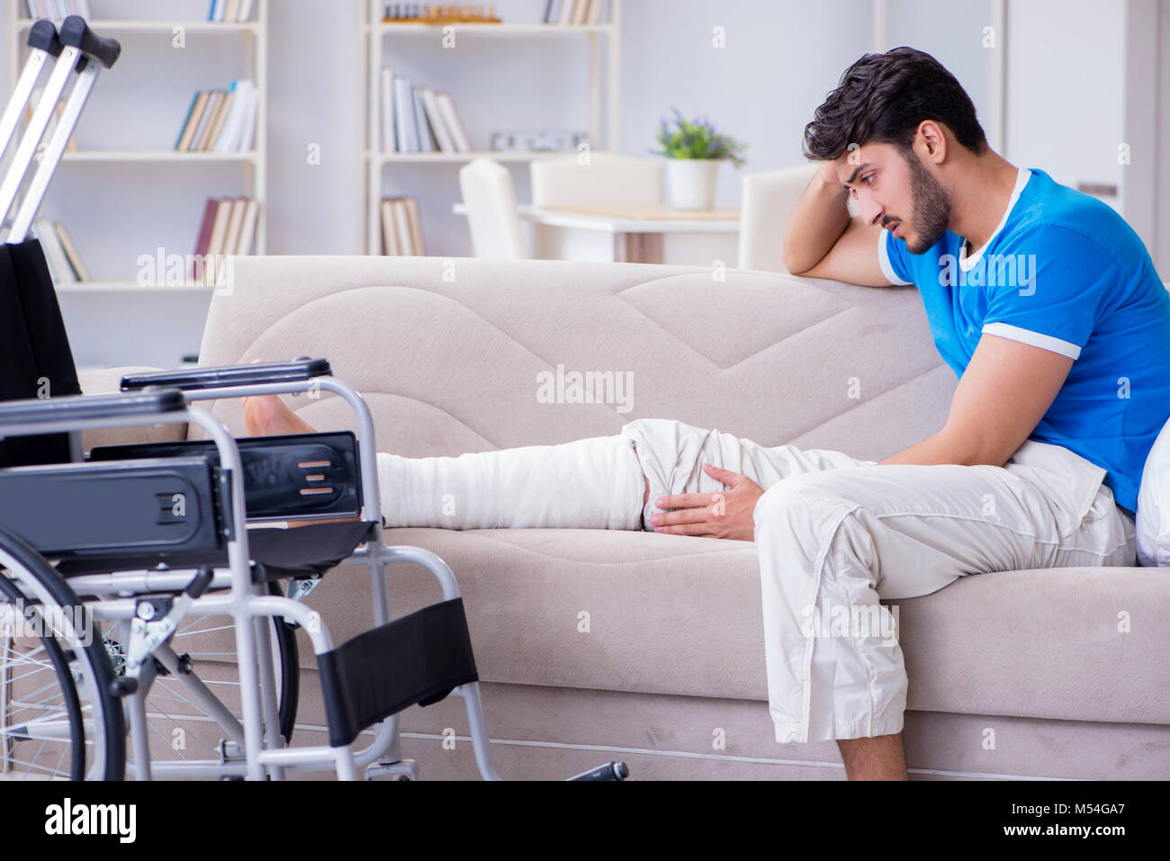Injured young man recovering at home Stock Photo - Alamy