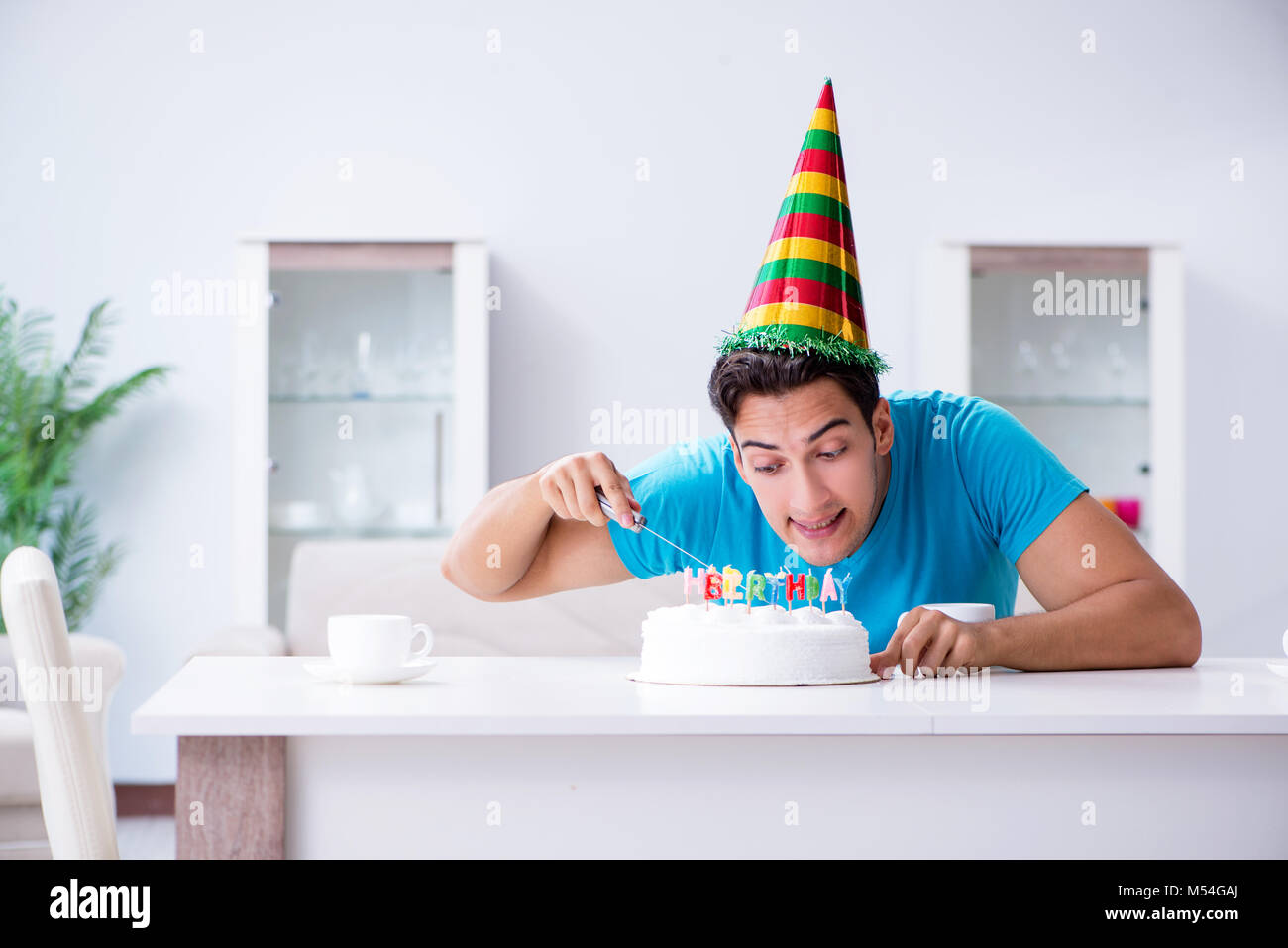 Boy cutting birthday cake hi-res stock photography and images - Alamy