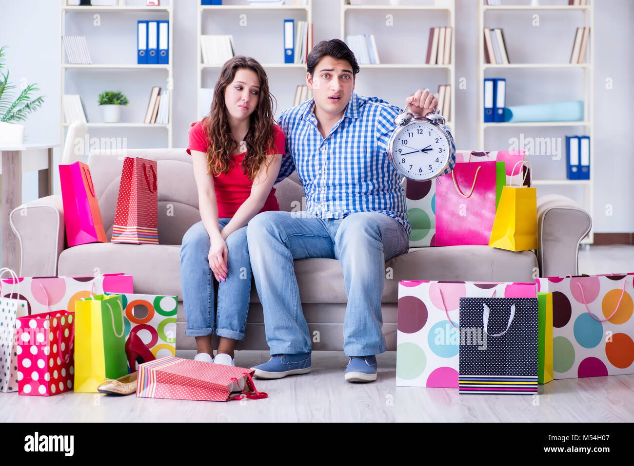 Young pair after shopping with many bags Stock Photo - Alamy