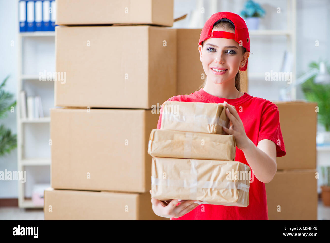 Young woman working in parcel distribution center Stock Photo - Alamy