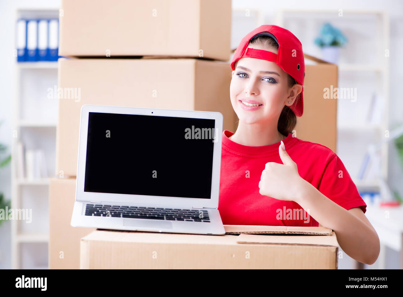 Young woman delivering boxes of personal effects Stock Photo - Alamy