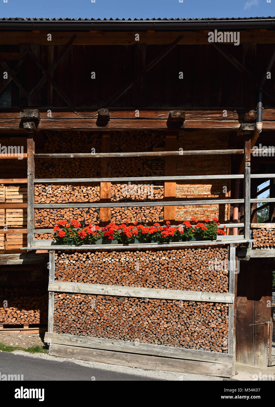 timber house; stacked firewood; wooden pile; dolomite alps; Italy ...