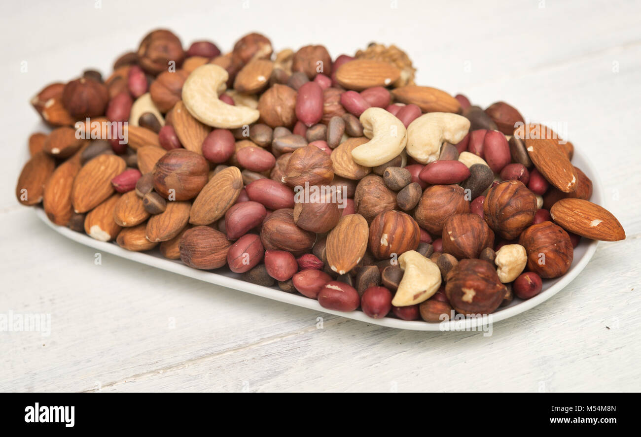 mixed nuts on a plate Stock Photo - Alamy