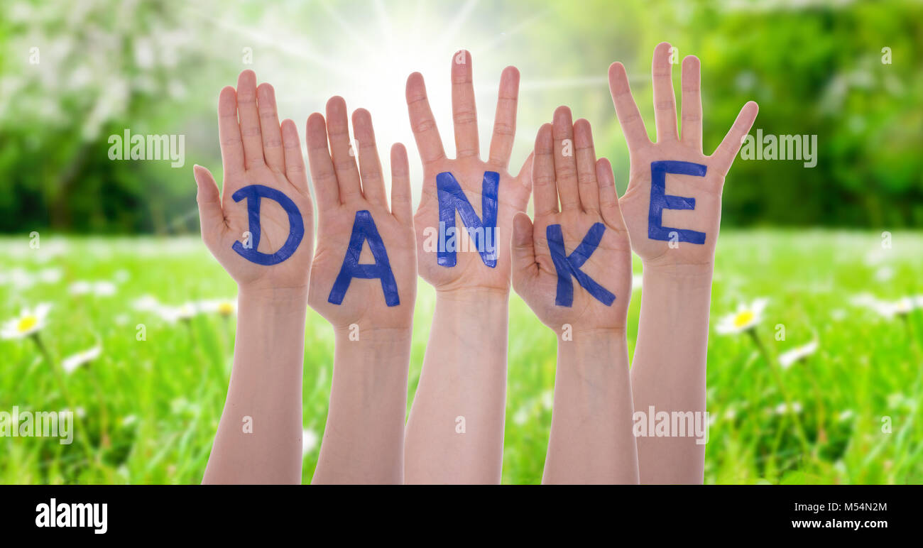 Word Danke Means Thank You On Hands, Sunny Meadow Stock Photo - Alamy