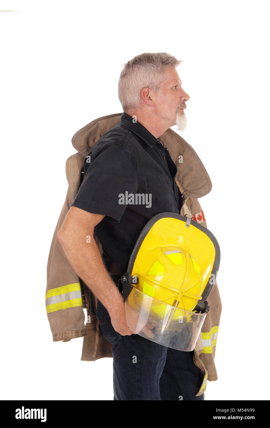 A firefighter standing in profile Stock Photo - Alamy