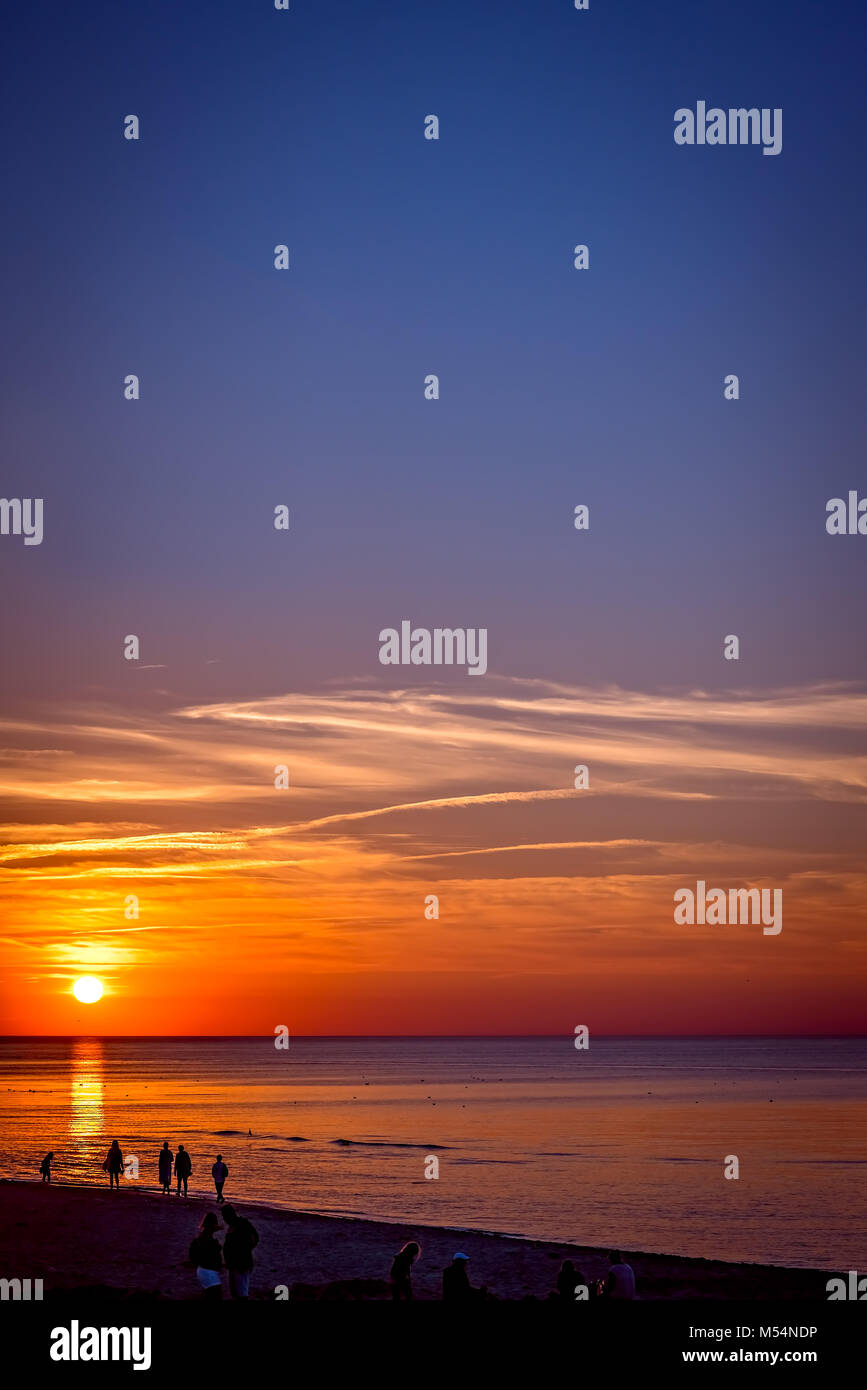 People walking on the sea beach at sunset Stock Photo - Alamy