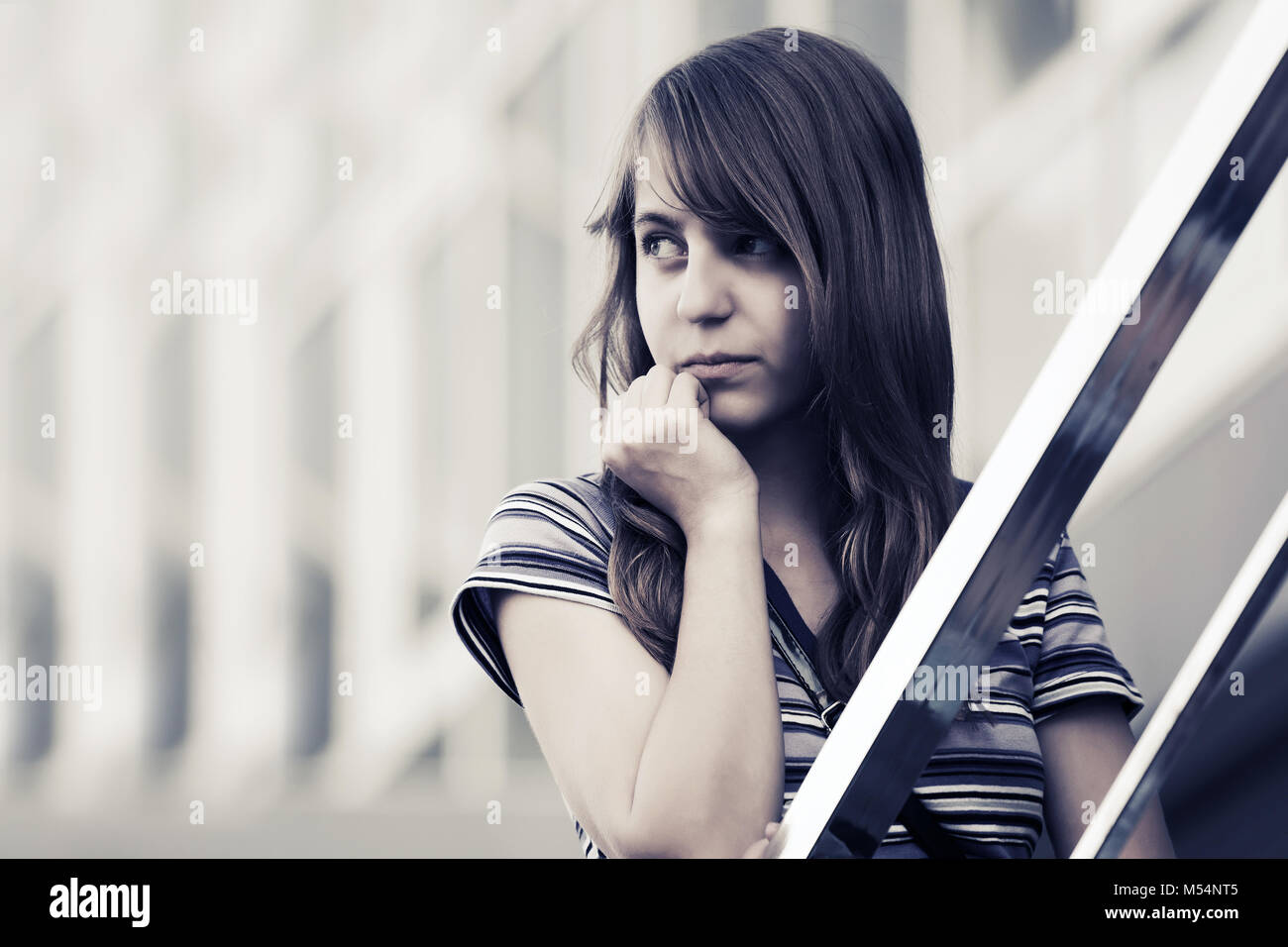 Sad young girl against a school building Stock Photo - Alamy