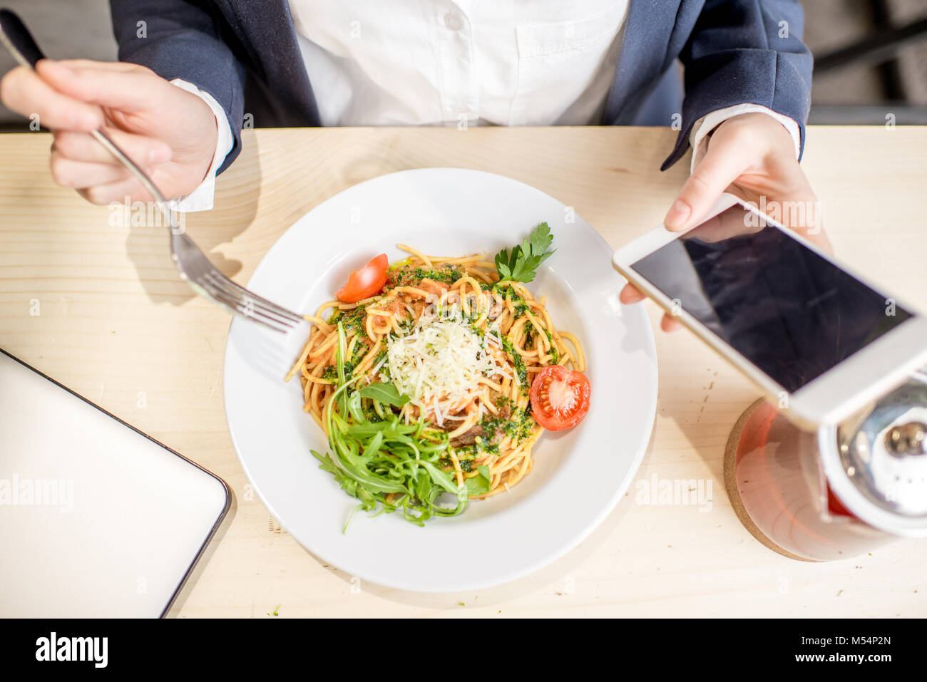 Businesswoman eating pasta Stock Photo - Alamy