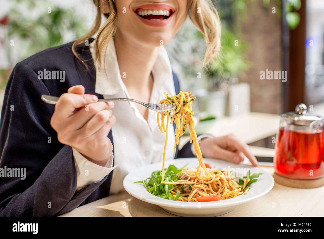 Happy woman eating pasta hi-res stock photography and images - Alamy