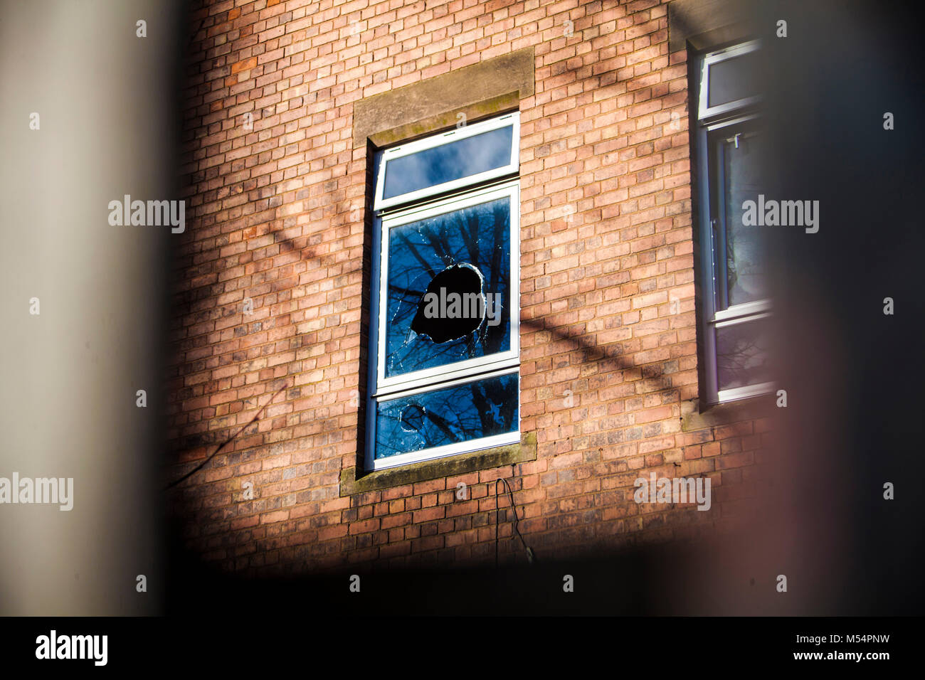 A broken window in an old abandoned building. Broken glass on the ...