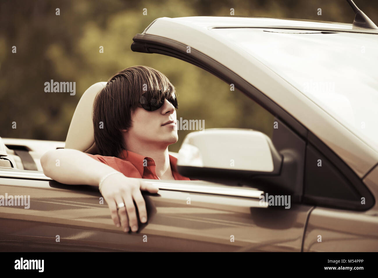 Young man driving a convertible car Stock Photo - Alamy