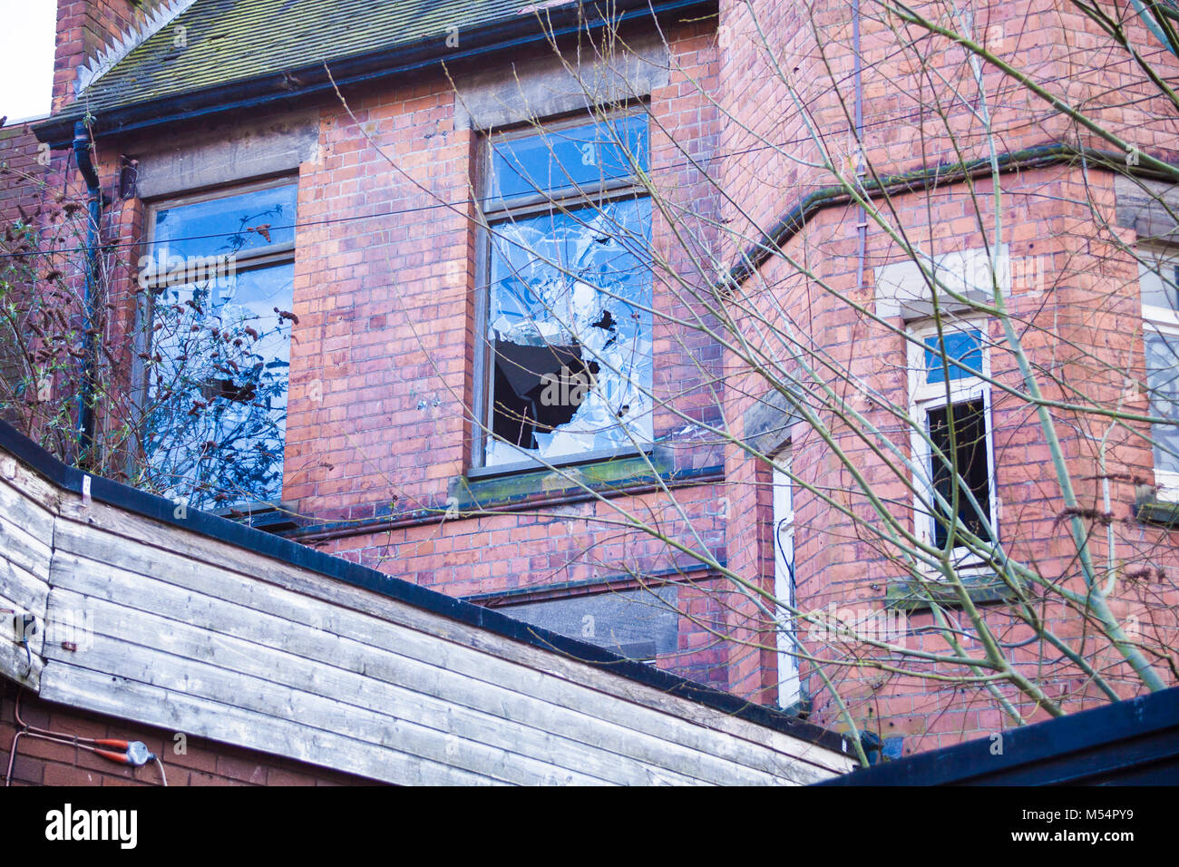 A broken window in an old abandoned building. Broken glass on the ...