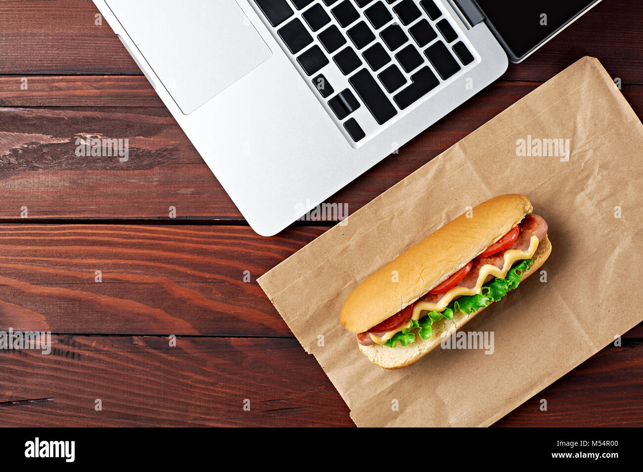 Business lunch in the office workspace, top view of Hot Dog on wooden ...