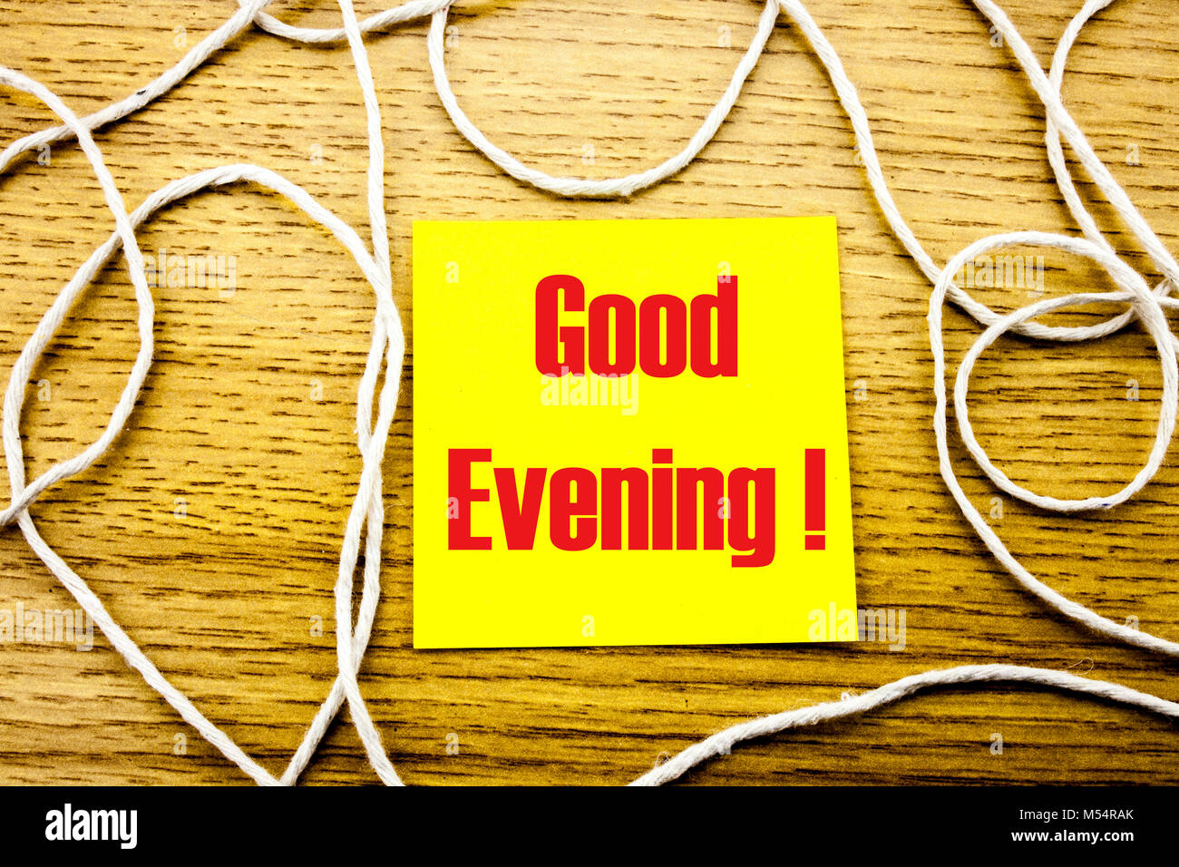 Good Evening. word on yellow sticky note in wooden background. Bussines ...