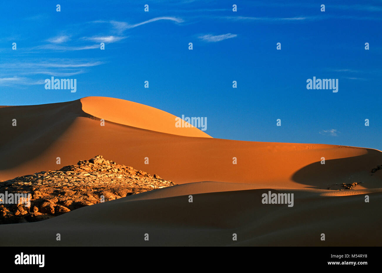 Algeria. Near Djanet. Sahara desert. Sand dunes and rocks Stock Photo ...