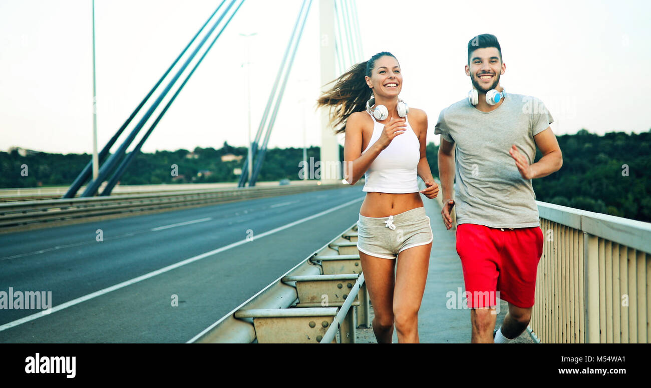 Couple jogging outdoors Stock Photo - Alamy