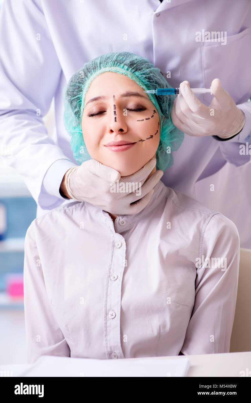 The plastic surgeon preparing for operation on woman face Stock Photo ...