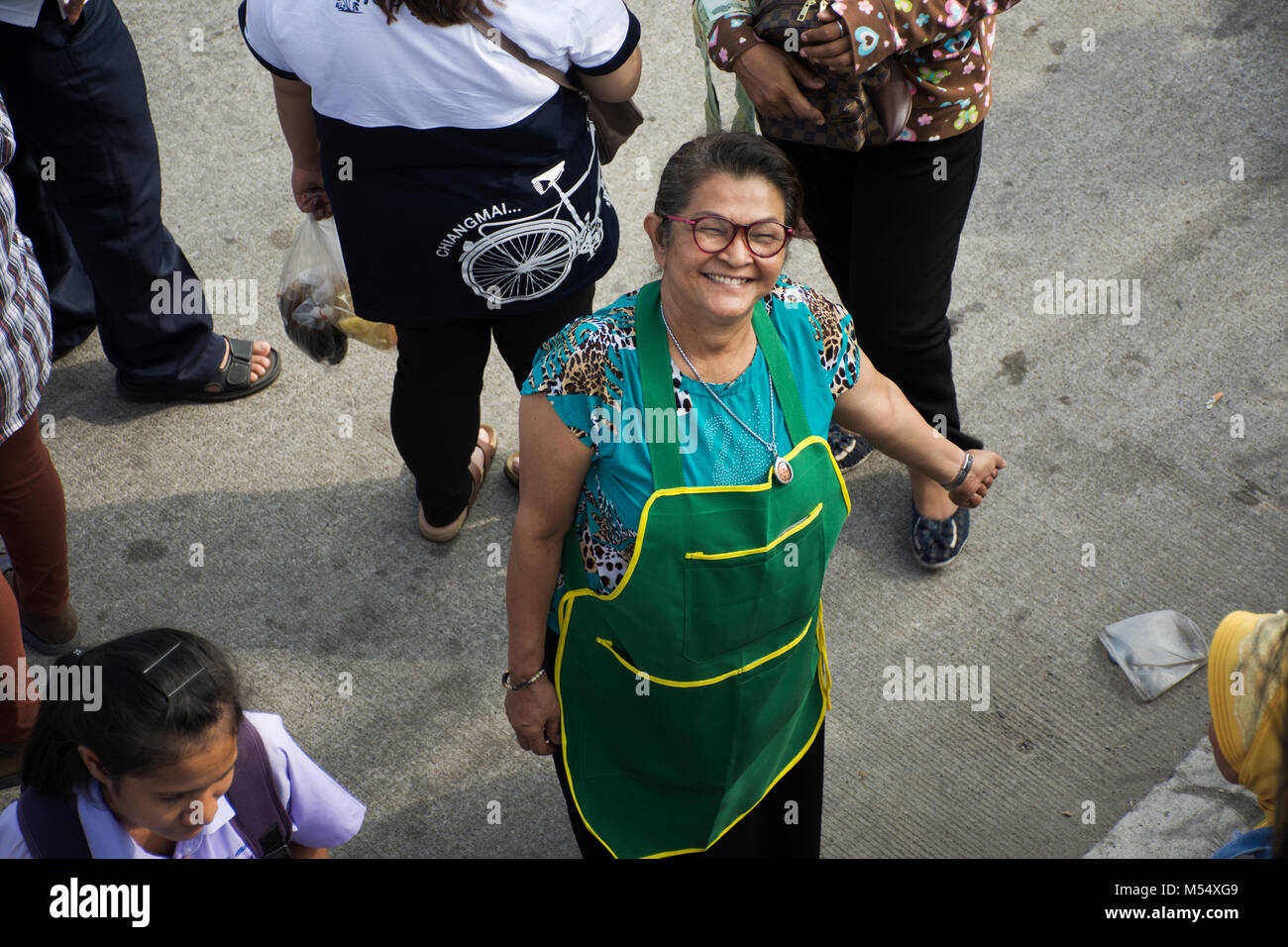 Thai old women standing and smile in crowd people on the road in ...
