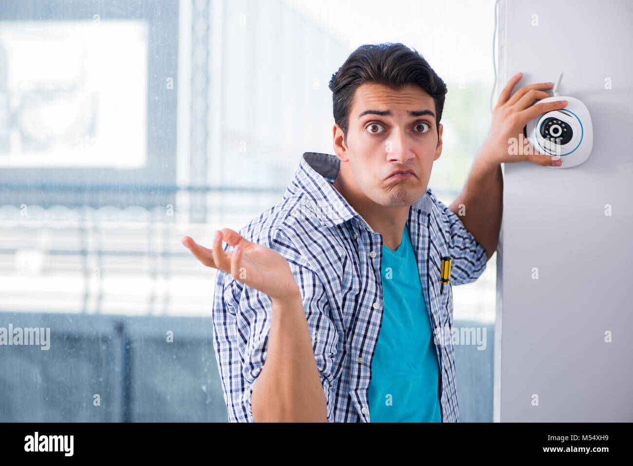 The man installing surveillance cctv cameras at home Stock Photo - Alamy