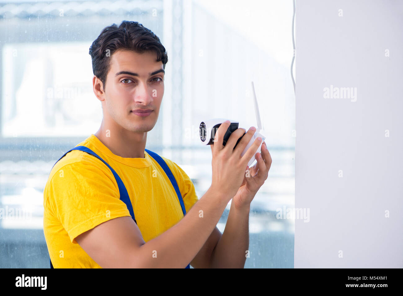 The contractor installing surveillance cctv cameras in office Stock ...