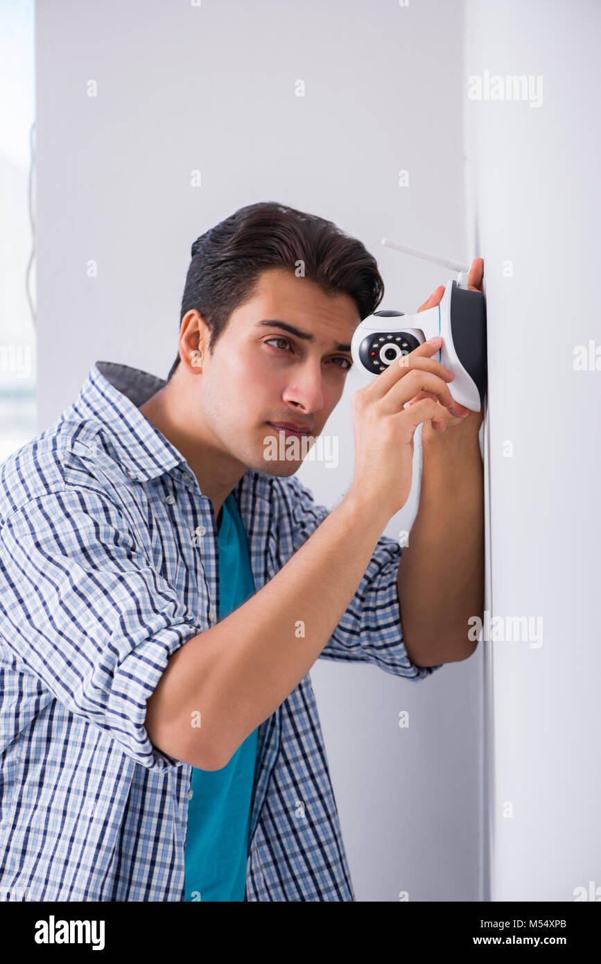 The man installing surveillance cctv cameras at home Stock Photo - Alamy