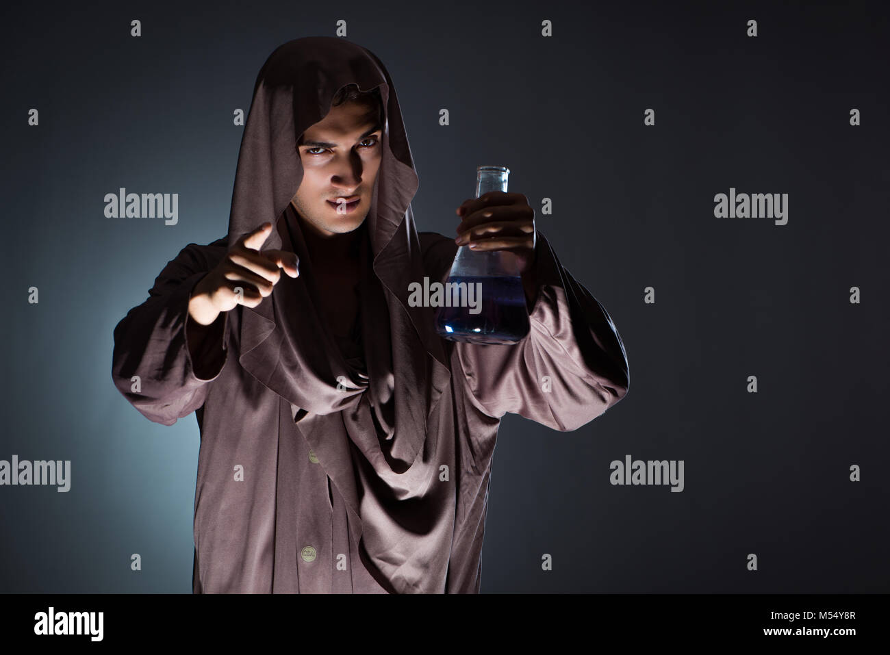 The alchemist doing experiments in alchemy concept Stock Photo - Alamy