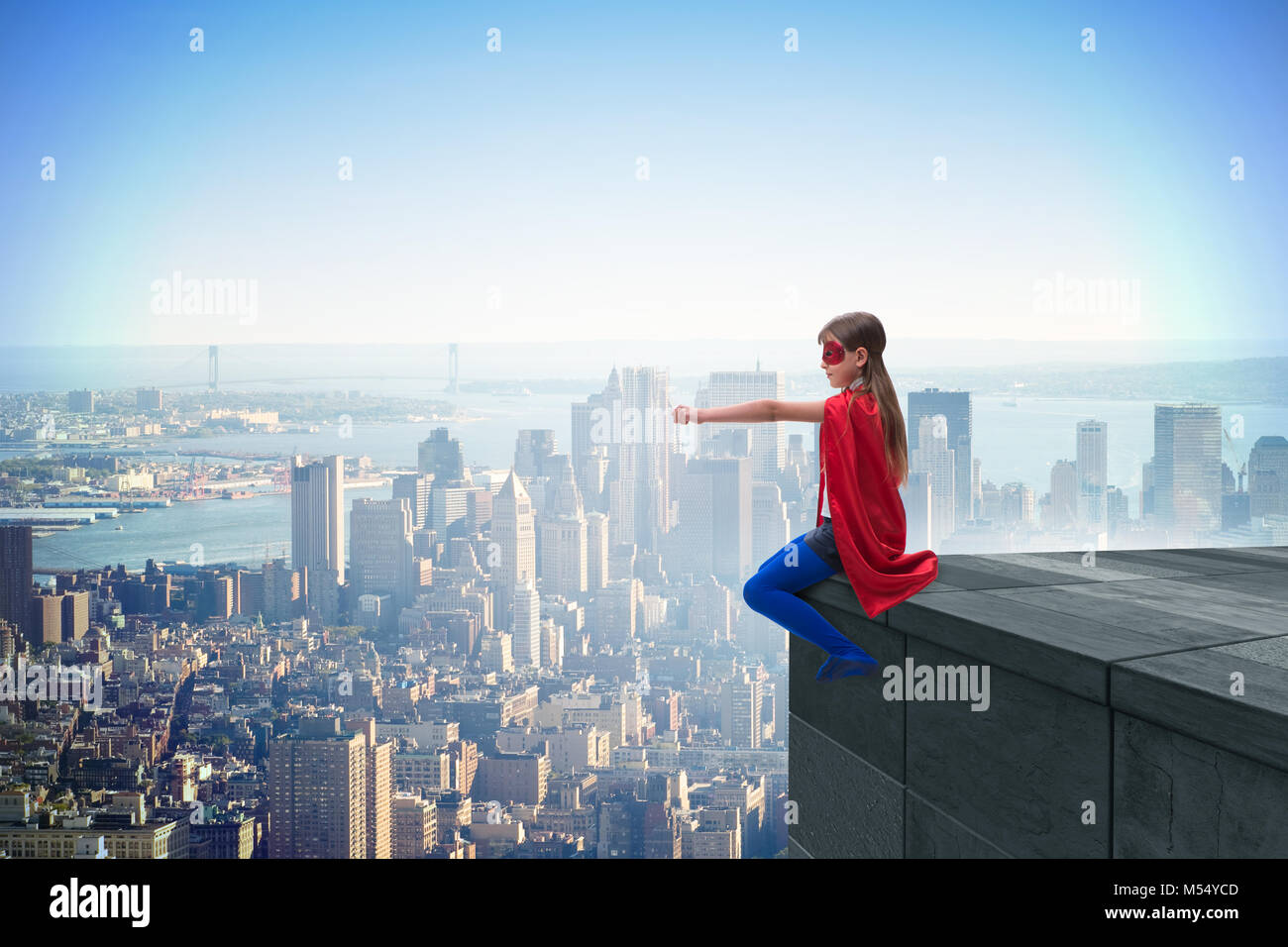 The young girl in superhero costume overlooking the city Stock Photo ...